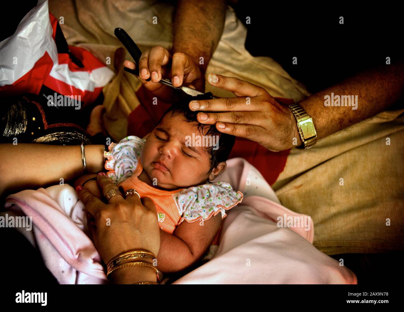 Shaving an Infants head during New Year Celebrations at the Hindu ...