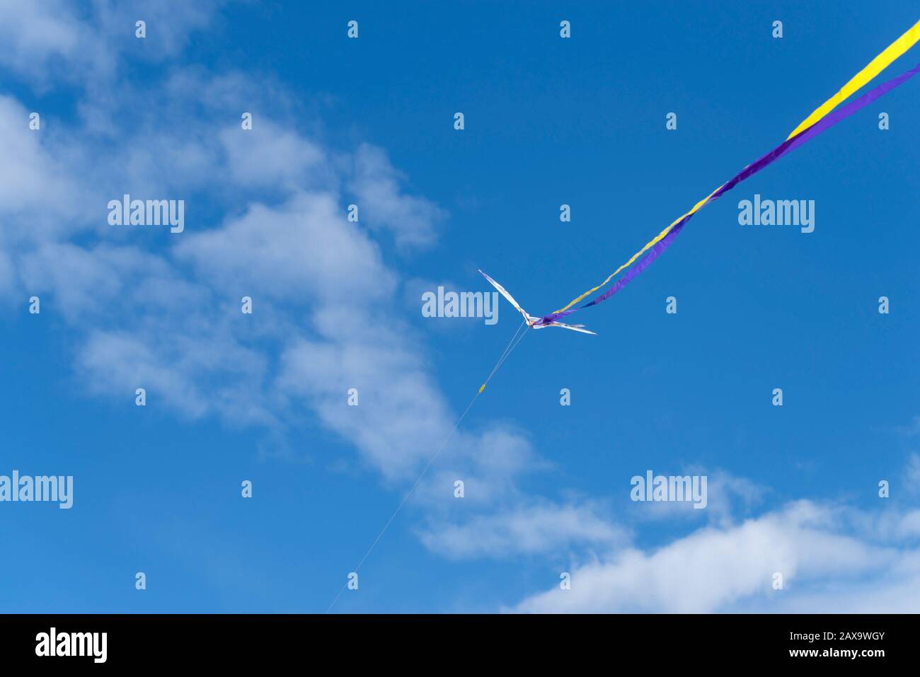 Low angle view of kite flying in cloudy sky Stock Photo - Alamy