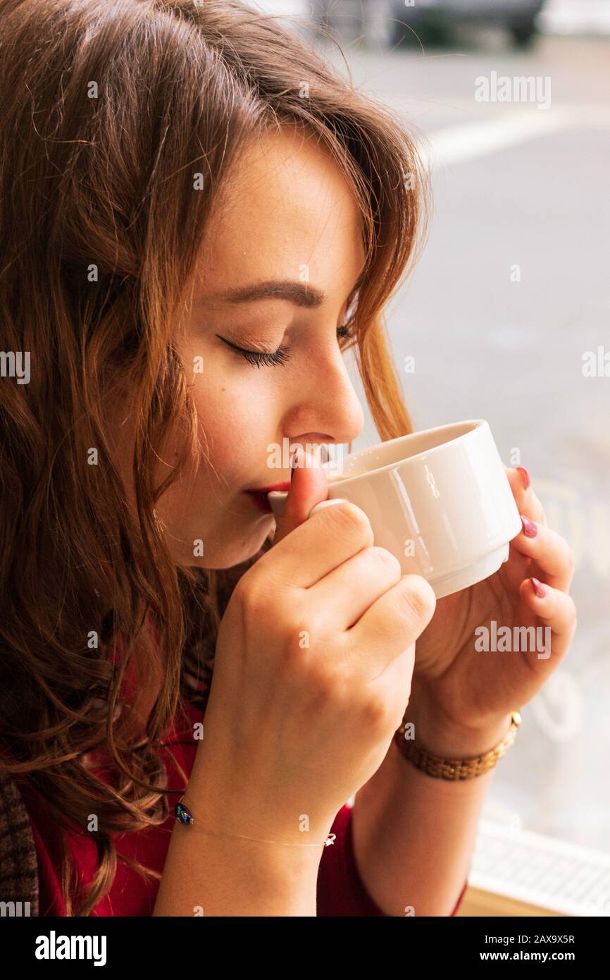 beautiful young girl drinking coffee Stock Photo - Alamy