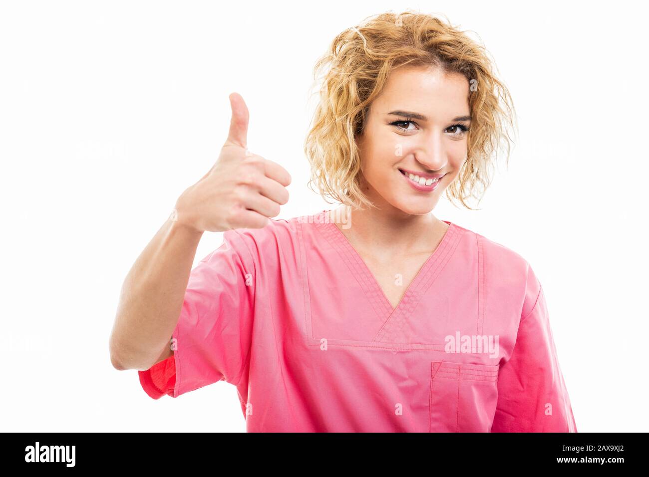 Portrait Of Young Nurse Wearing Pink Scrub Showing Like Gesture
