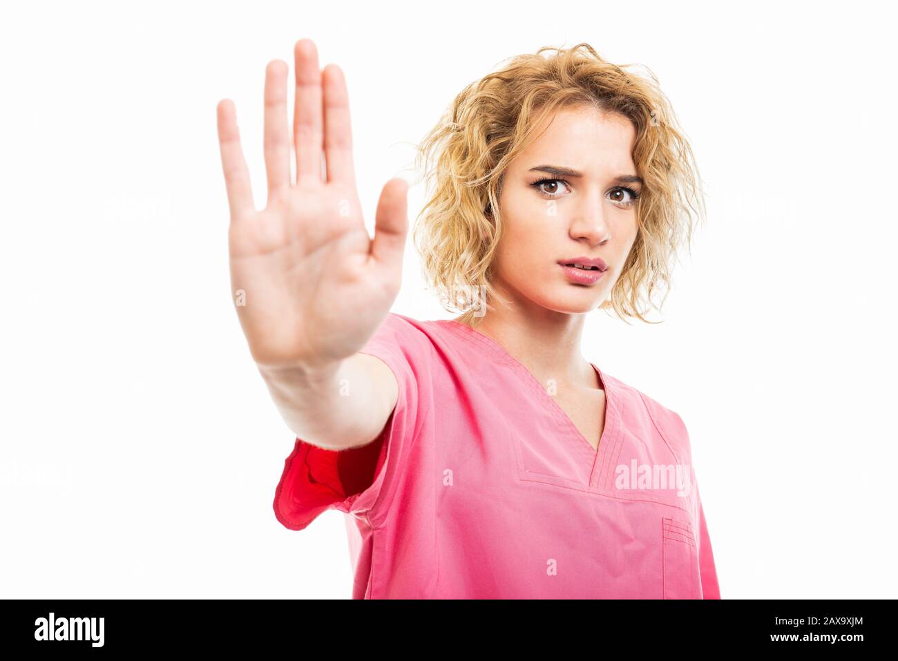 Portrait Of Nurse Wearing Pink Scrub Showing Stop Gesture Isolated On