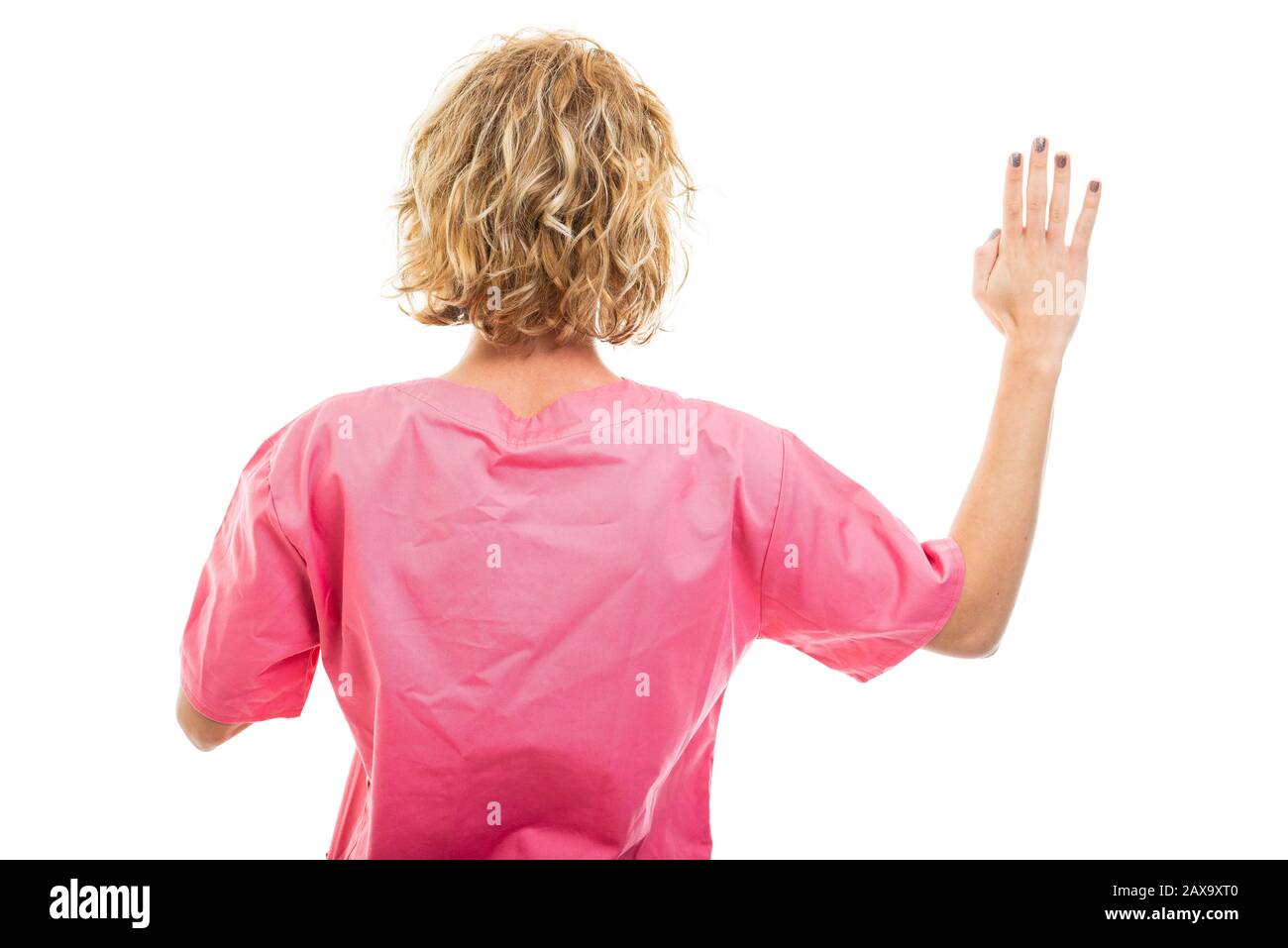 Back view of young nurse wearing pink scrub making oath gesture ...
