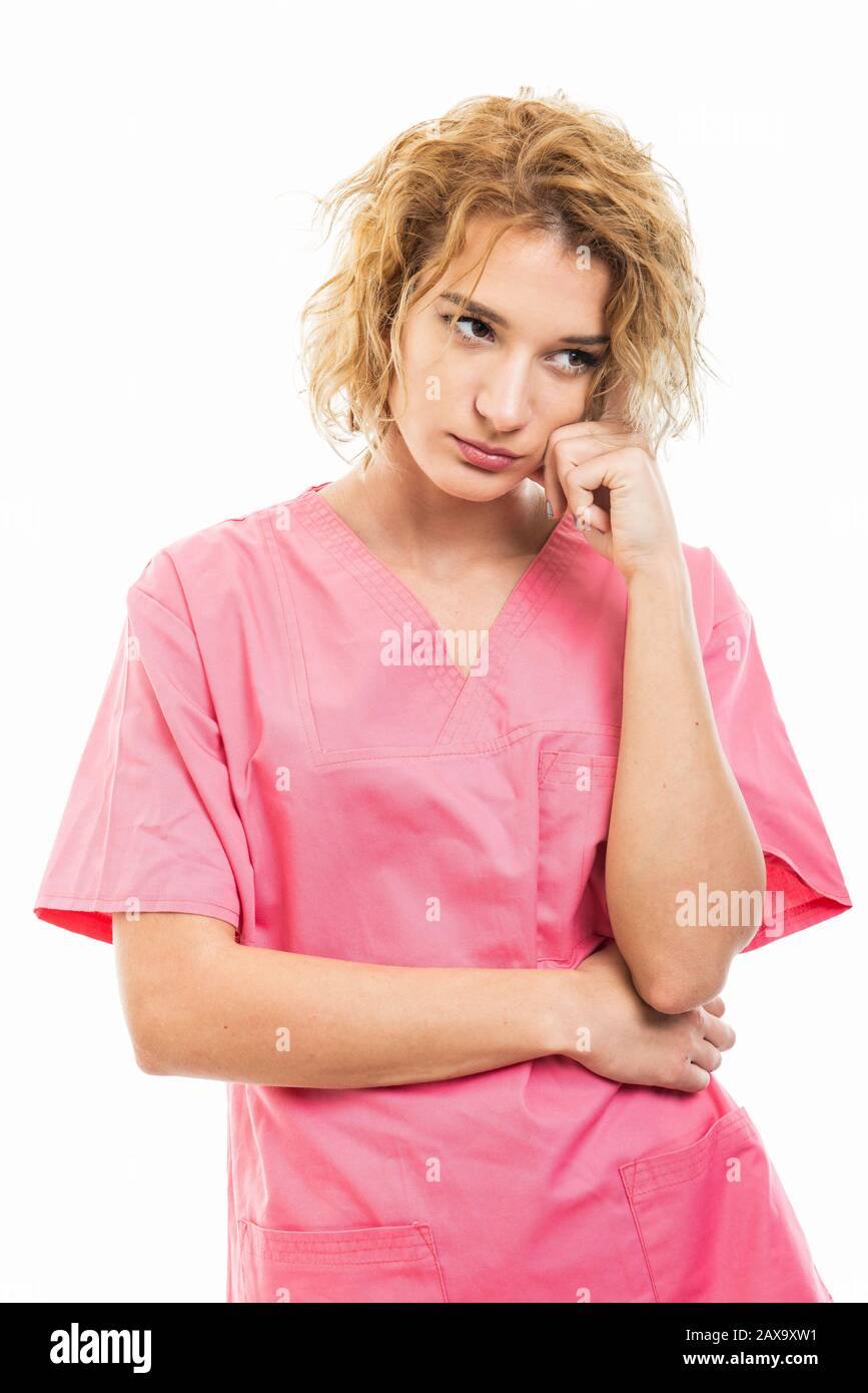 Portrait Of Young Nurse Wearing Pink Scrub Making Thinking Gesture