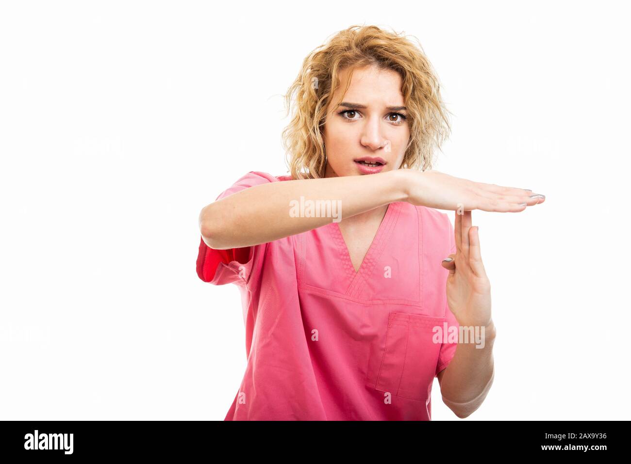 Portrait Of Nurse Wearing Pink Scrub Showing Time Out Gesture Isolated
