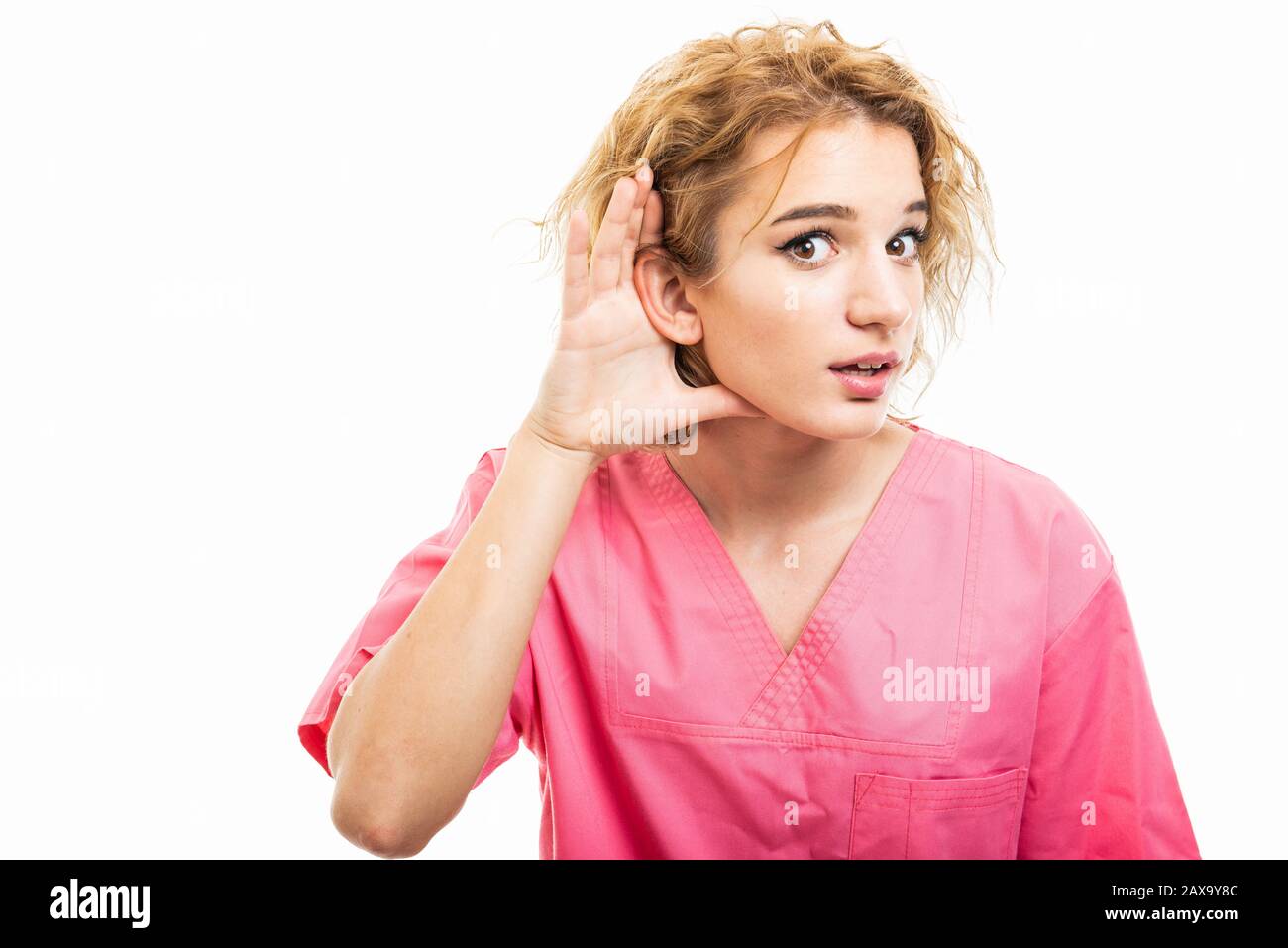 Portrait Of Nurse Wearing Pink Scrub Making Cant Hear You Gesture