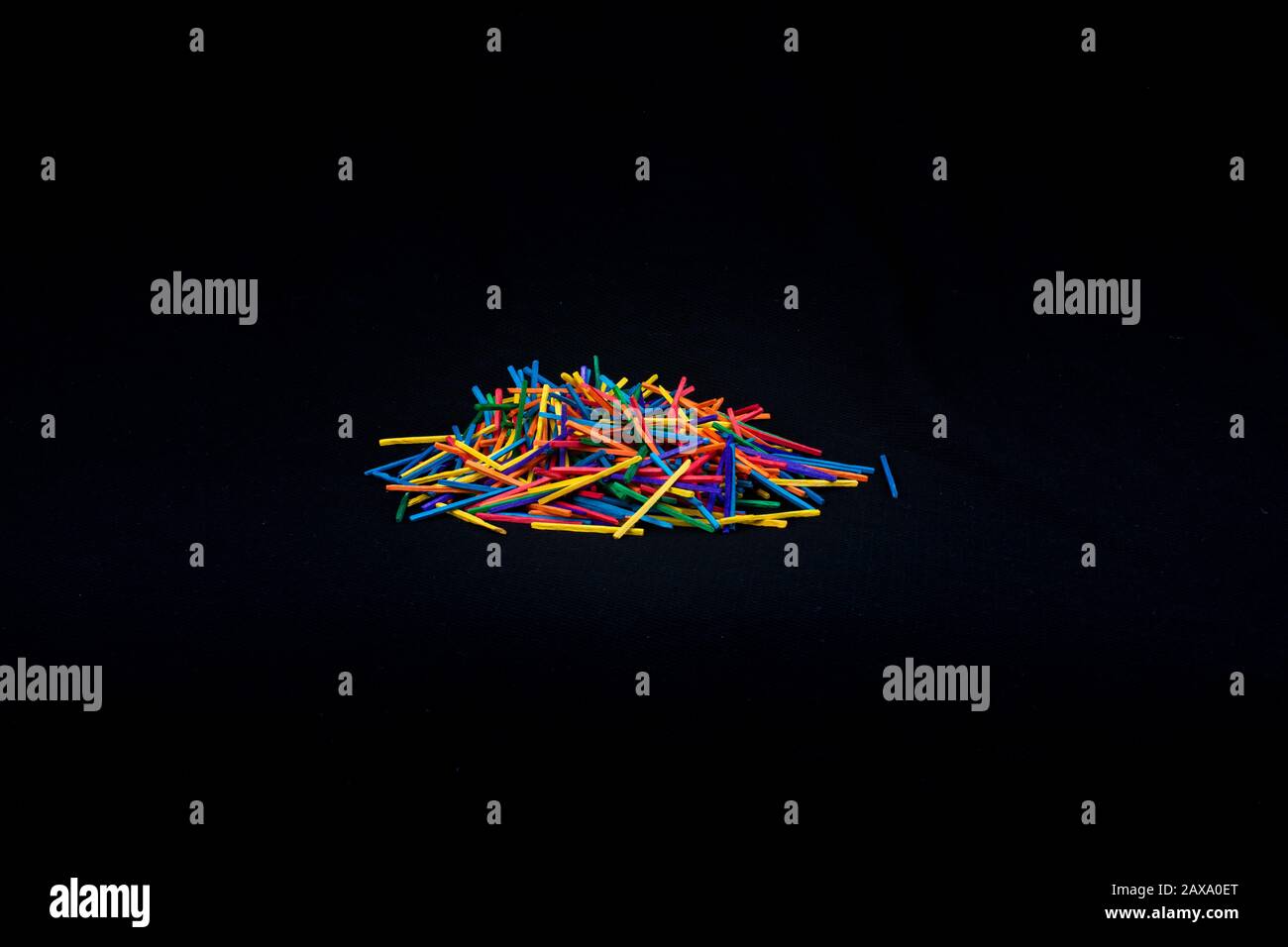 Beautiful coloured wooden sticks for creativity on black background ...