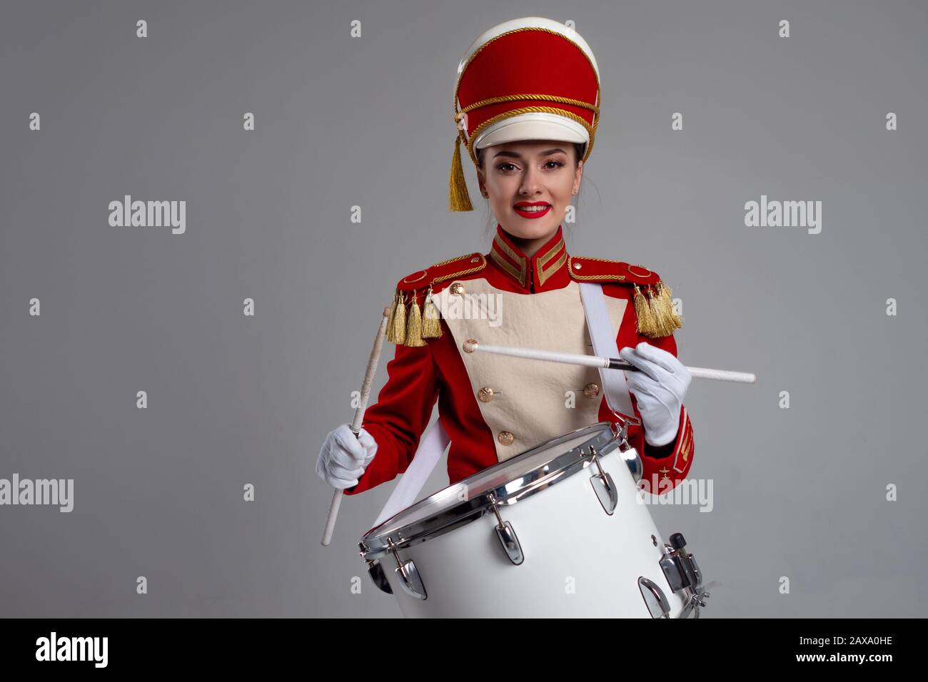 Drummer in a red uniform drums on a drum, show program and celebration ...