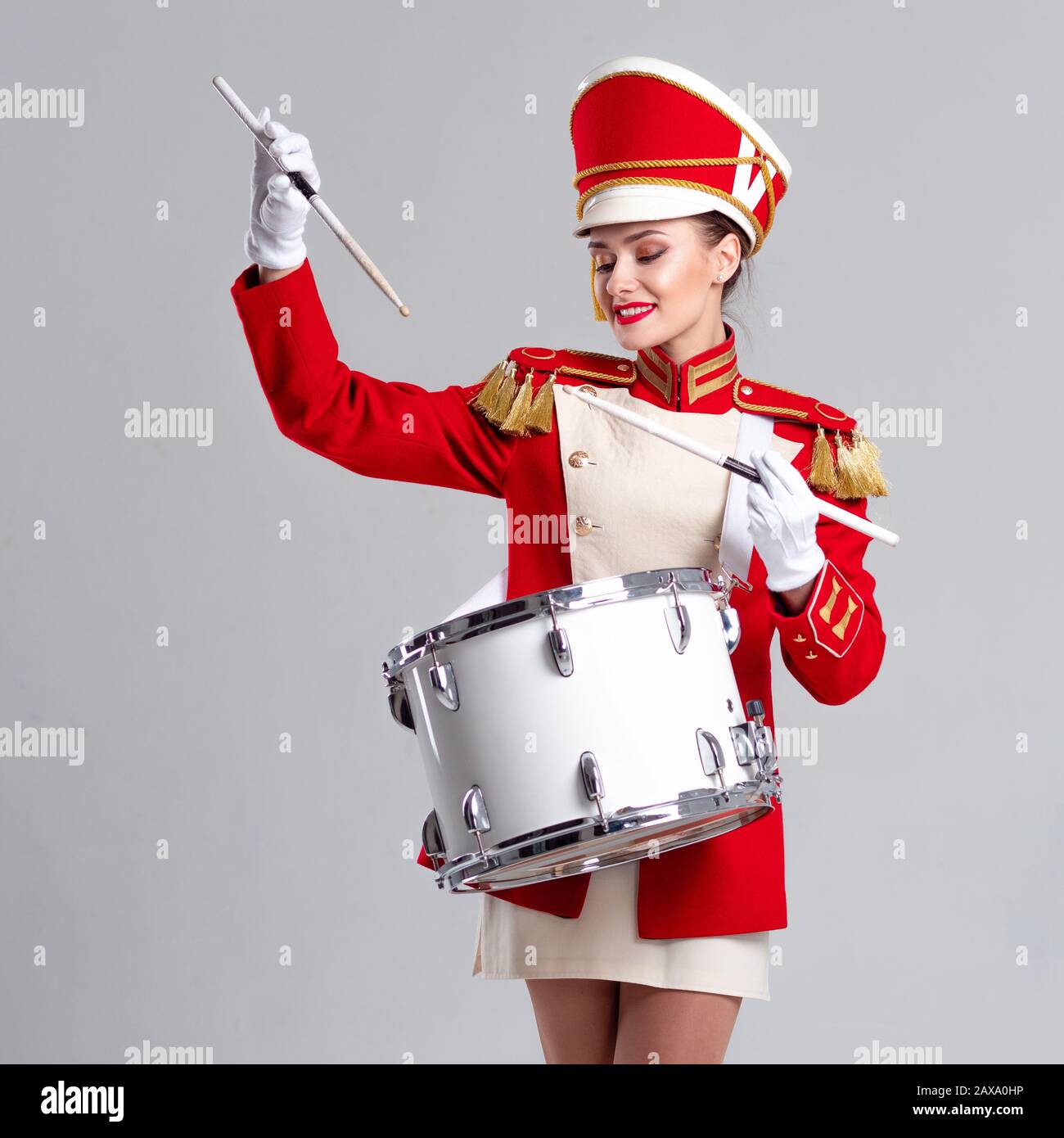 Drummer in a red uniform drums on a drum, show program and celebration ...
