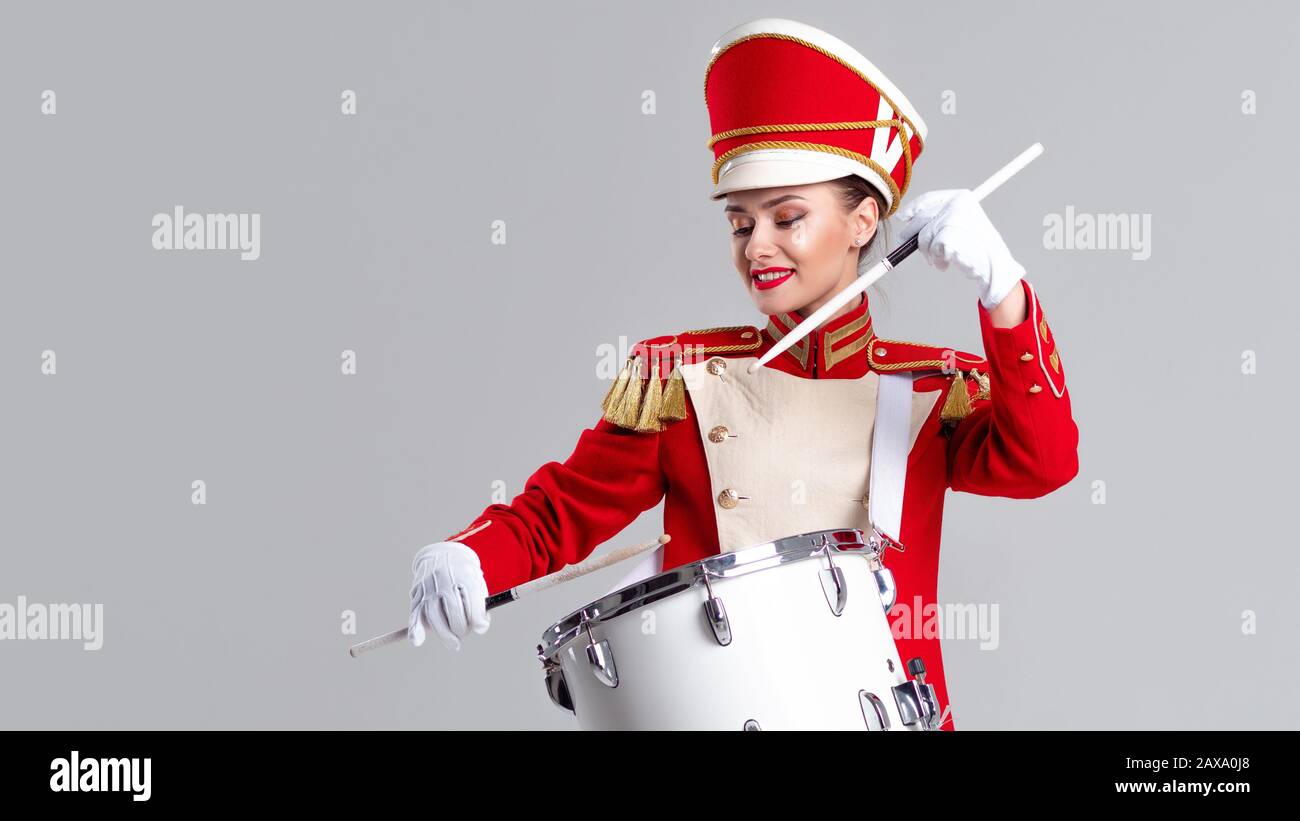 Drummer in a red uniform drums on a drum, show program and celebration ...