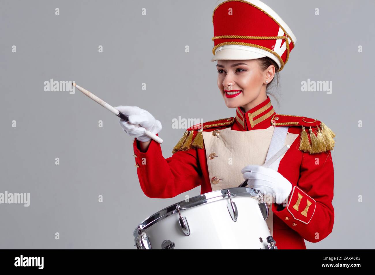 Drummer in a red uniform drums on a drum, show program and celebration ...