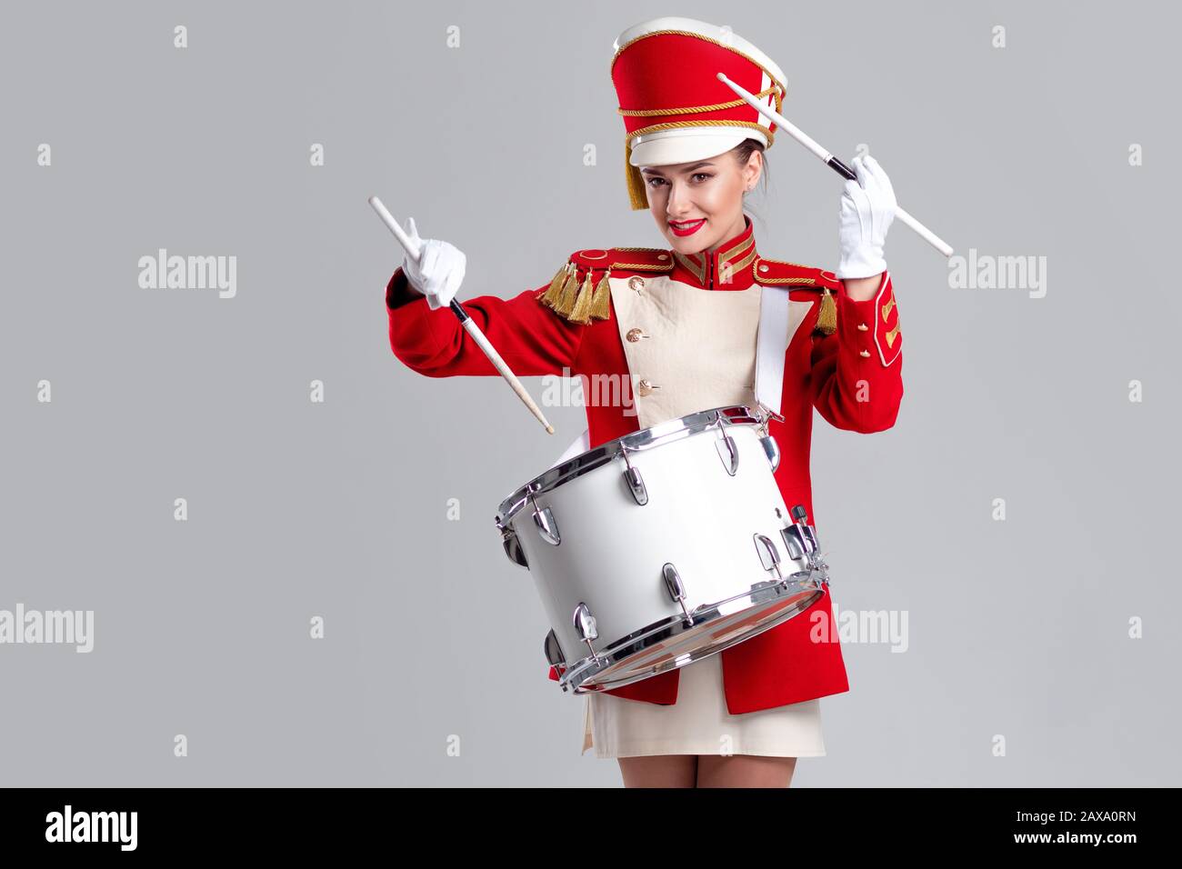 Drummer in a red uniform drums on a drum, show program and celebration ...