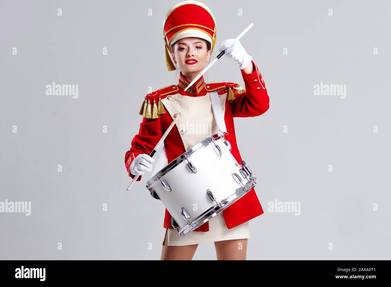 Drummer in a red uniform drums on a drum, show program and celebration ...