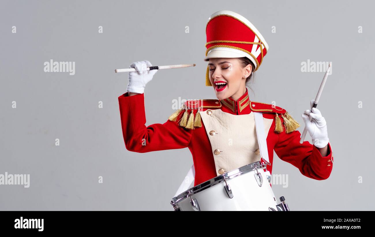 Drummer in a red uniform drums on a drum, show program and celebration ...