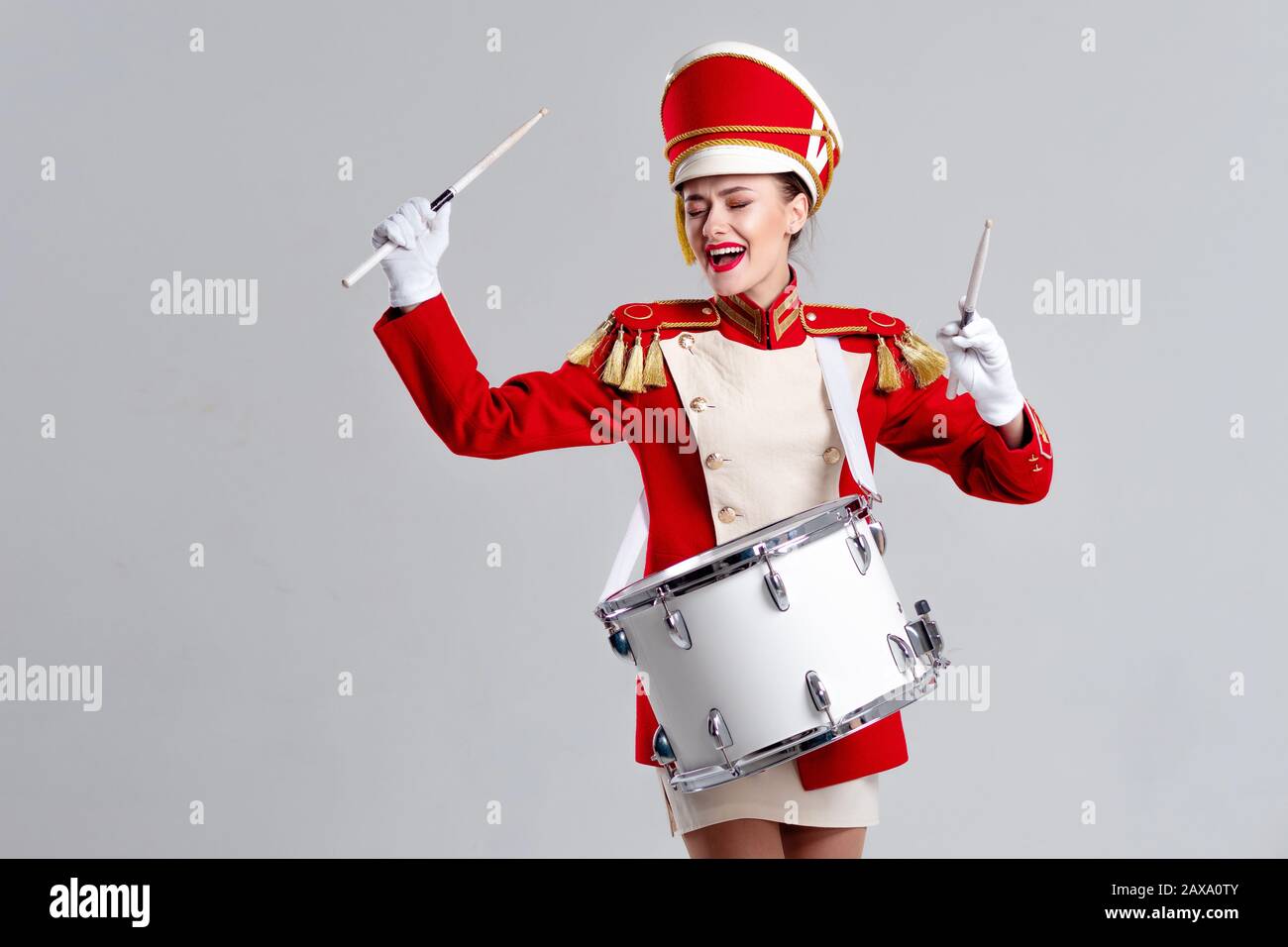 Drummer in a red uniform drums on a drum, show program and celebration ...