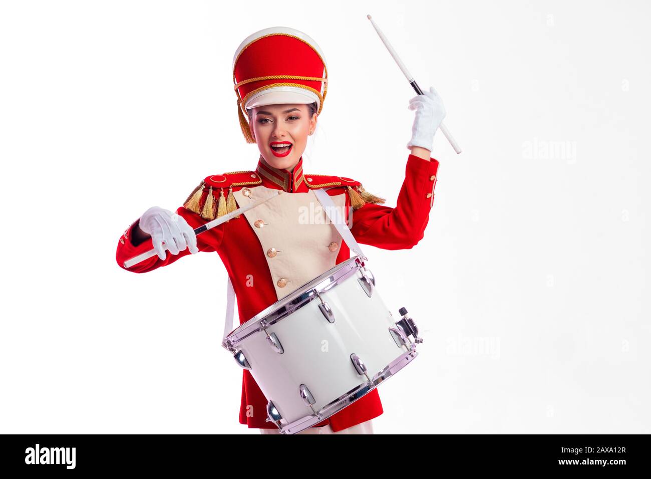 Drummer in a red uniform drums on a drum, show program and celebration ...