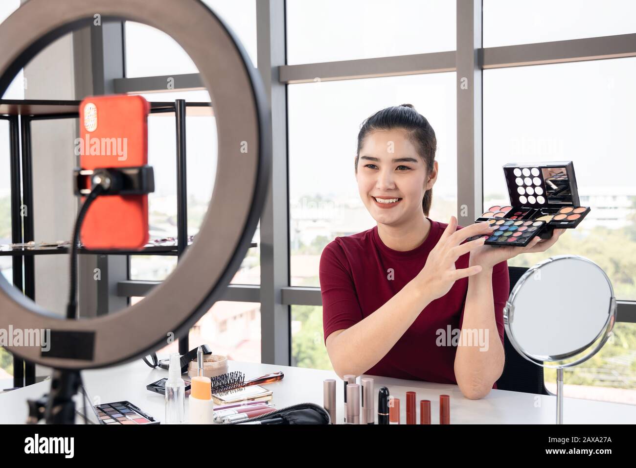 Beautiful Asian influencer review various type of cosmetics. Woman ...