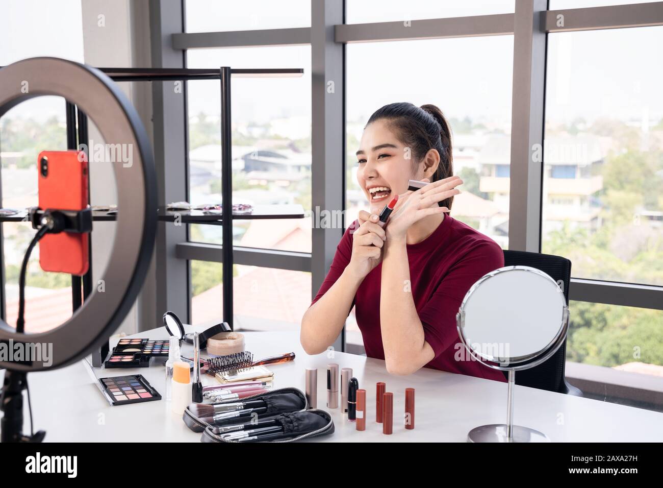 Beautiful Asian influencer review various type of cosmetics. Woman ...