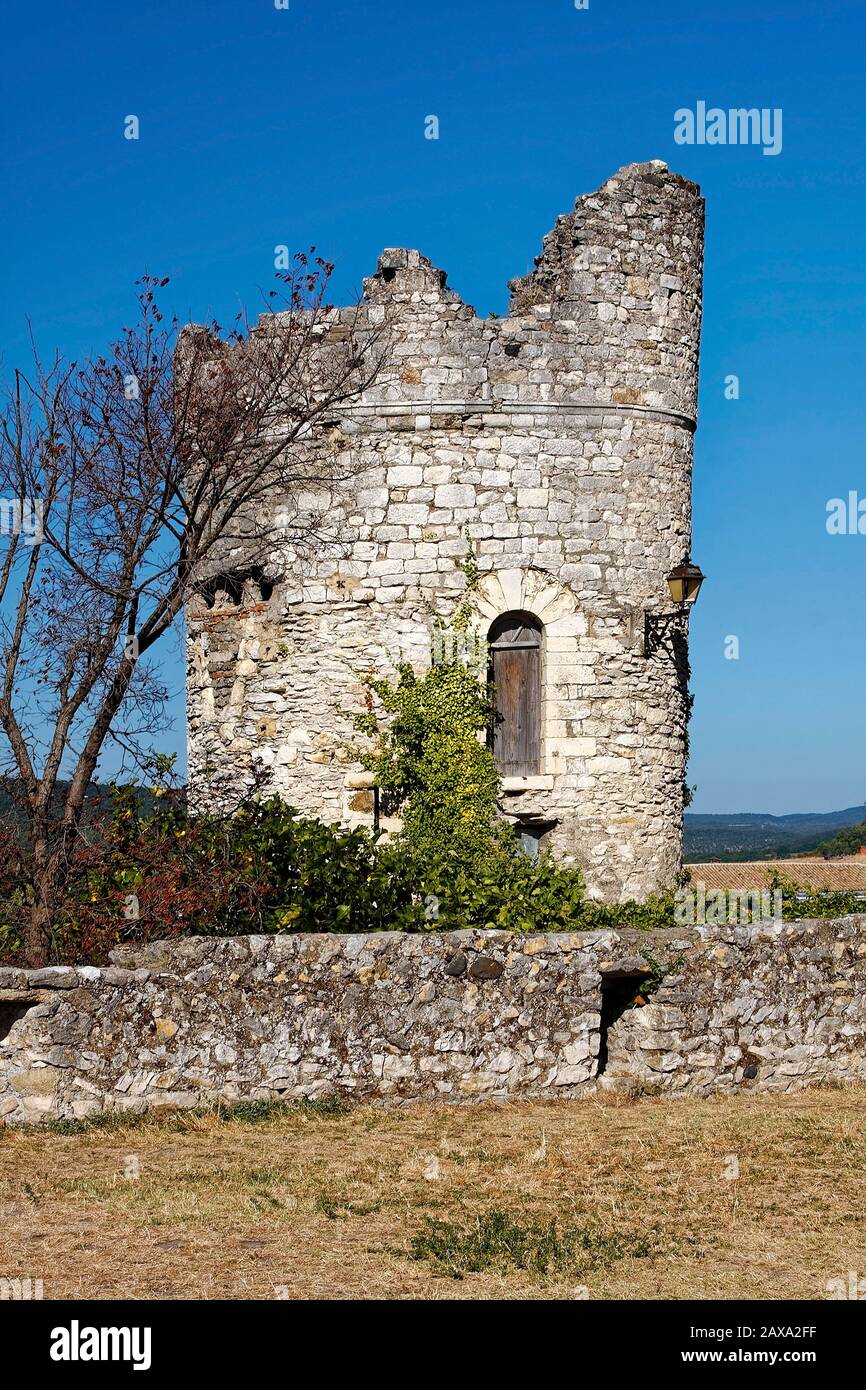 Medieval stone tower, old, abandoned, crumbling, low stone wall ...
