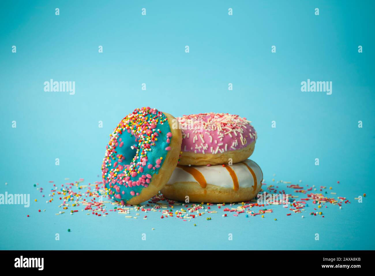 Donuts (doughnuts) of different colors on a blue background with multi ...
