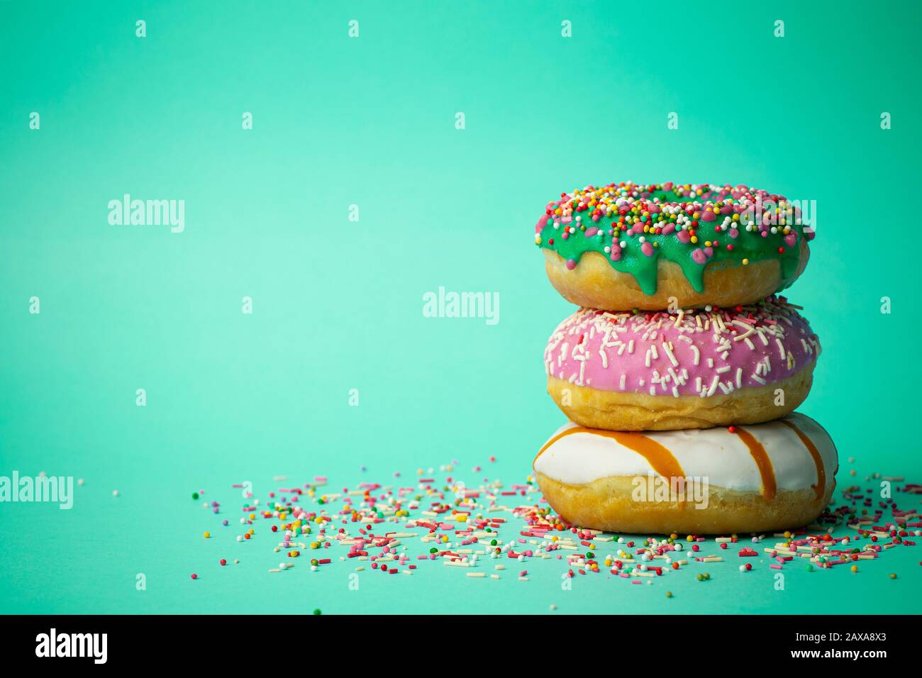 Donuts (doughnuts) of different colors on a green background with multi ...
