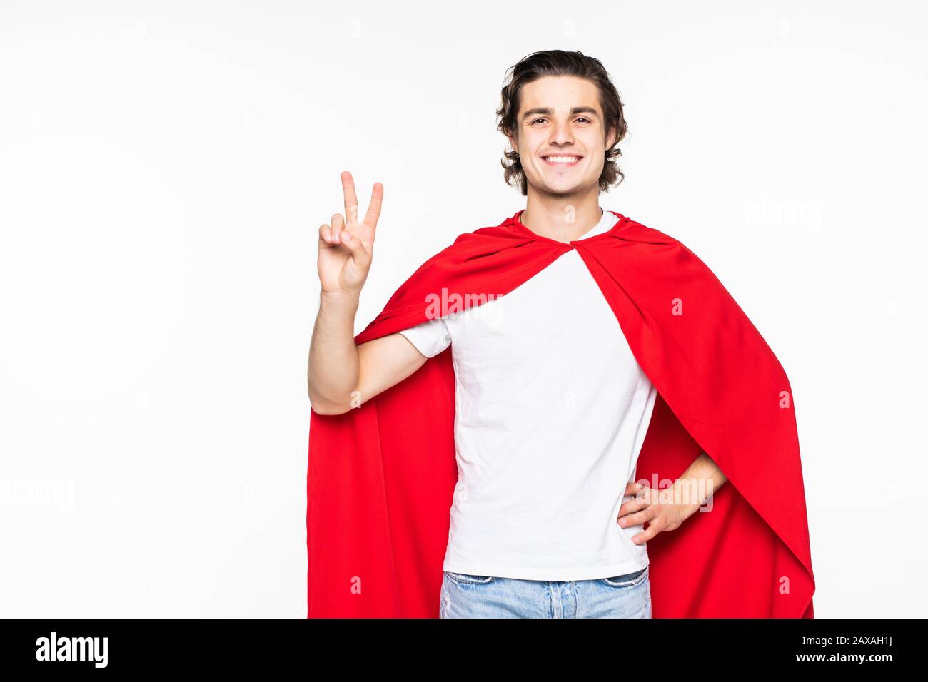 Portrait of man wearing bright super look outfit mantle isolated over ...