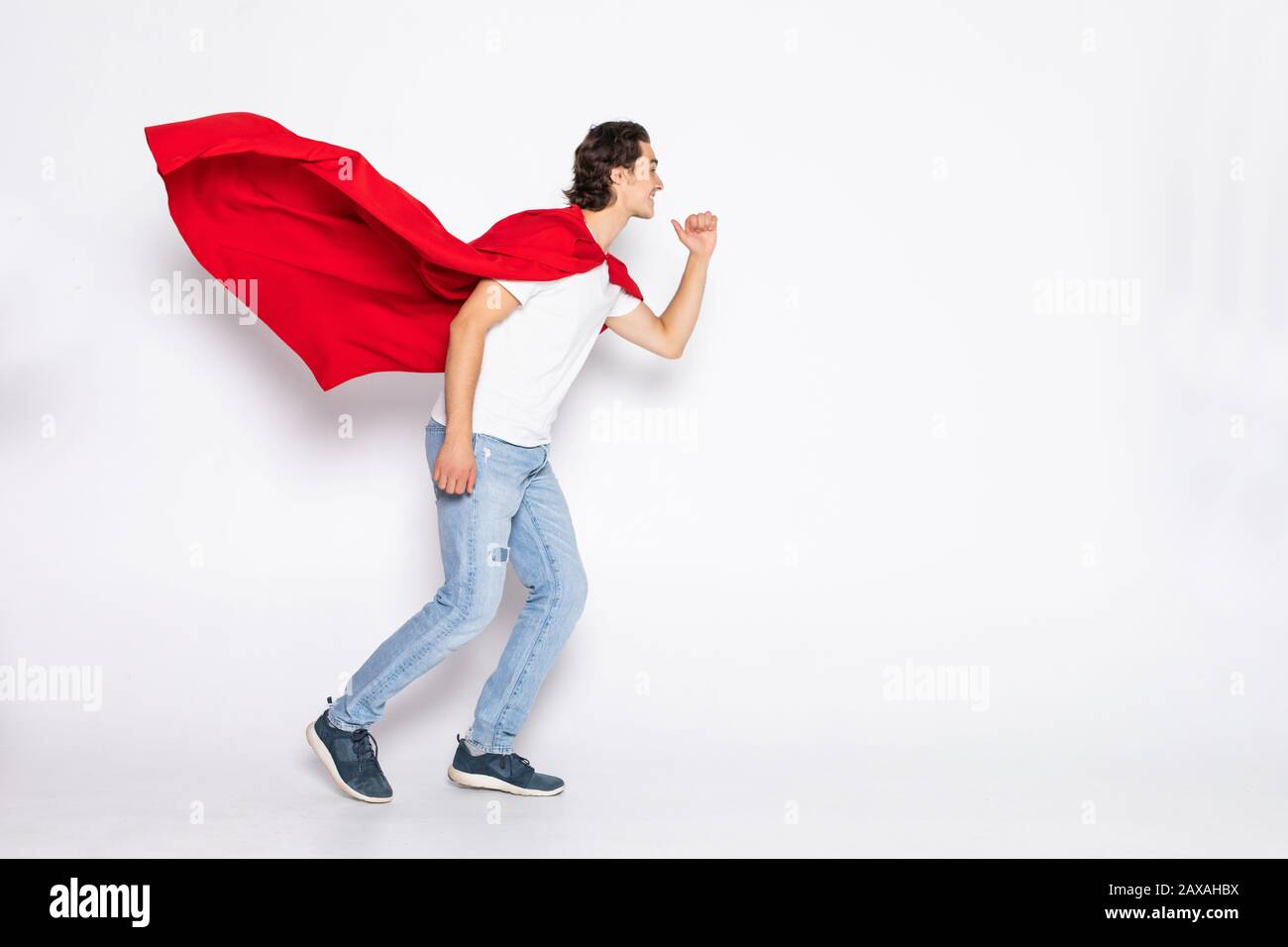 Portrait of man wearing bright super look outfit mantle isolated over ...