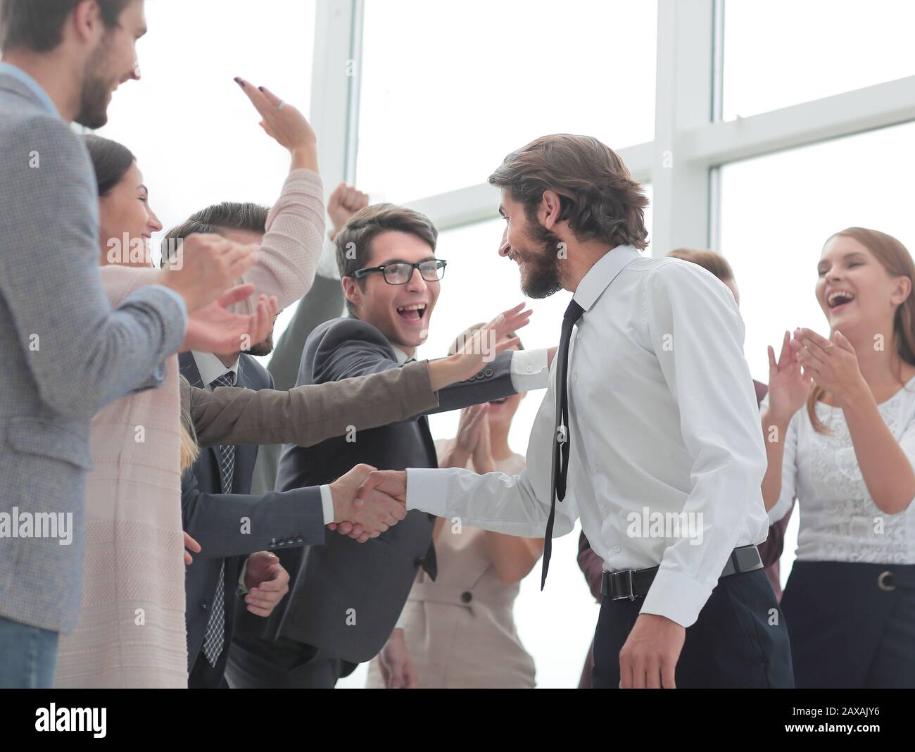 corporate group of employees congratulating each other on the victory ...