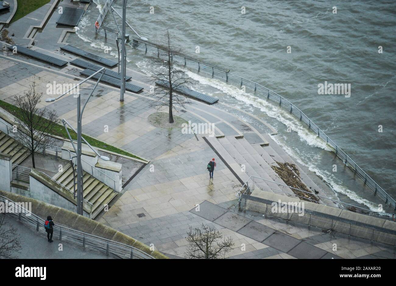 Hamburg, Germany. 11th Feb, 2020. In stormy and rainy weather, pedestrians walk through Hamburg ...
