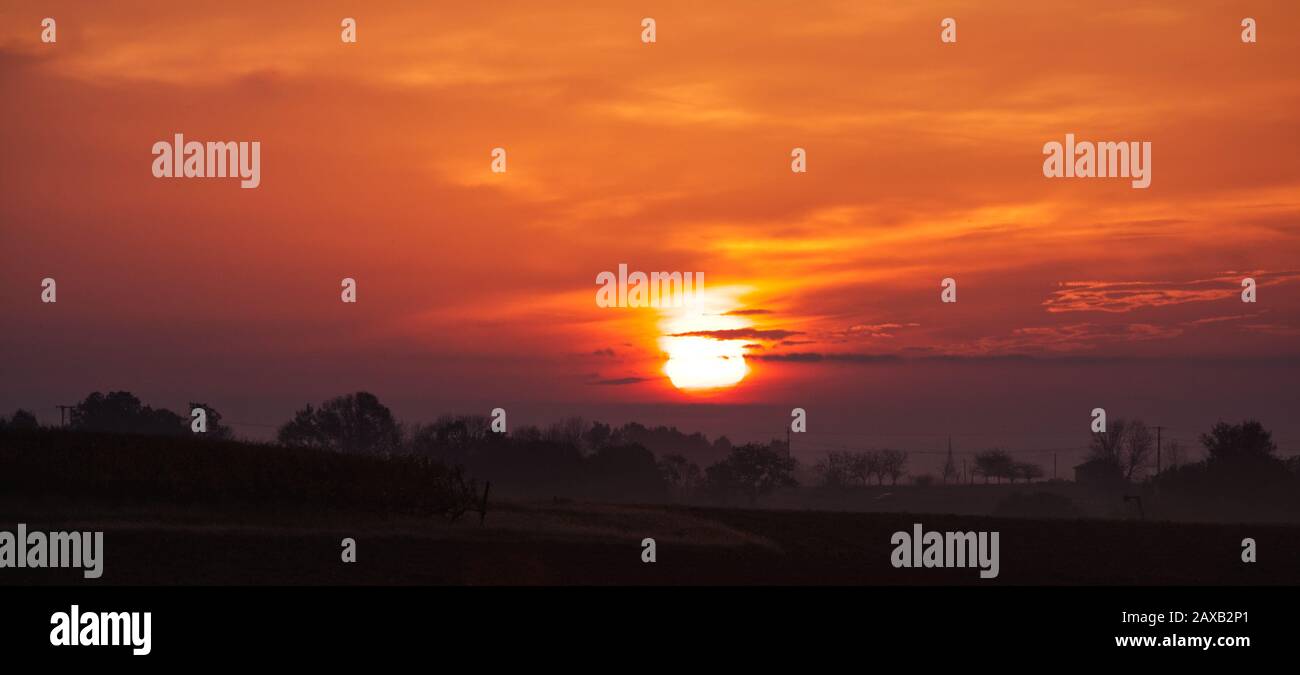 Sunrise causing a fiery red sky Stock Photo - Alamy