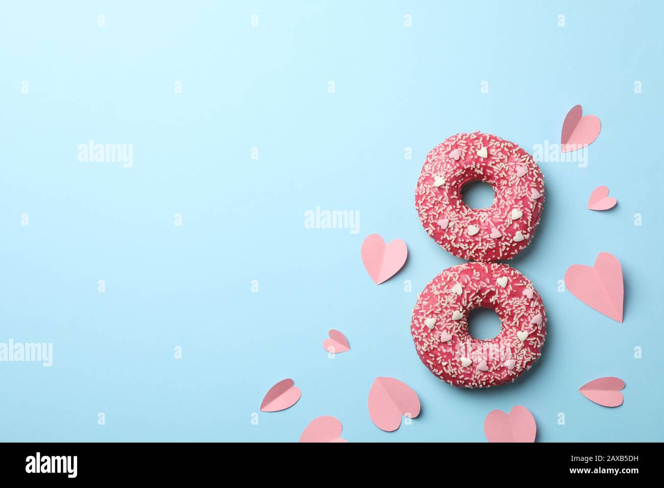 Eight made of donuts on blue background, top view Stock Photo - Alamy
