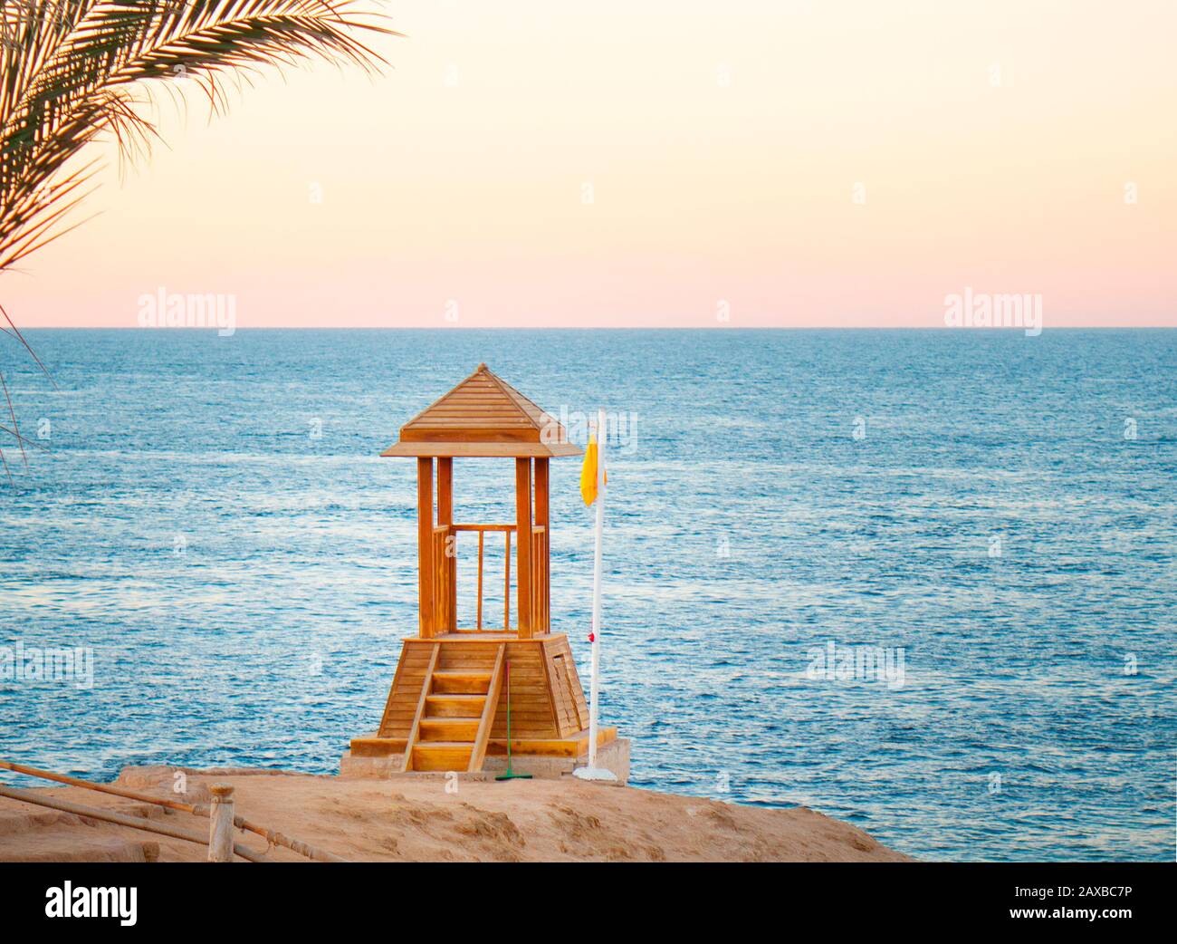 Scenery of the ocean sea at sunrise, lifeguard over a tropical beach ...