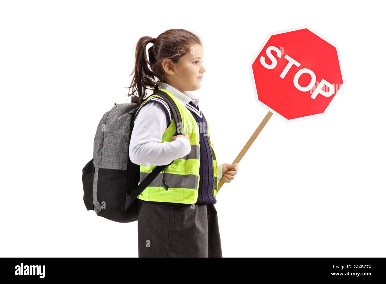 Schoolgirl with a stop sign wearing a safety vest isolated on white ...