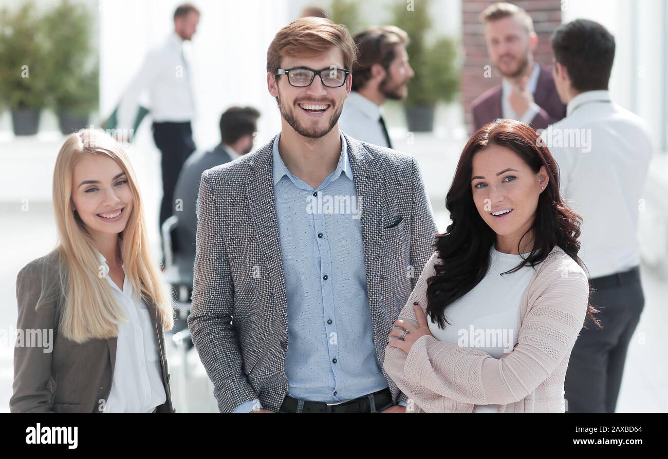close up. smiling young employees standing together Stock Photo - Alamy