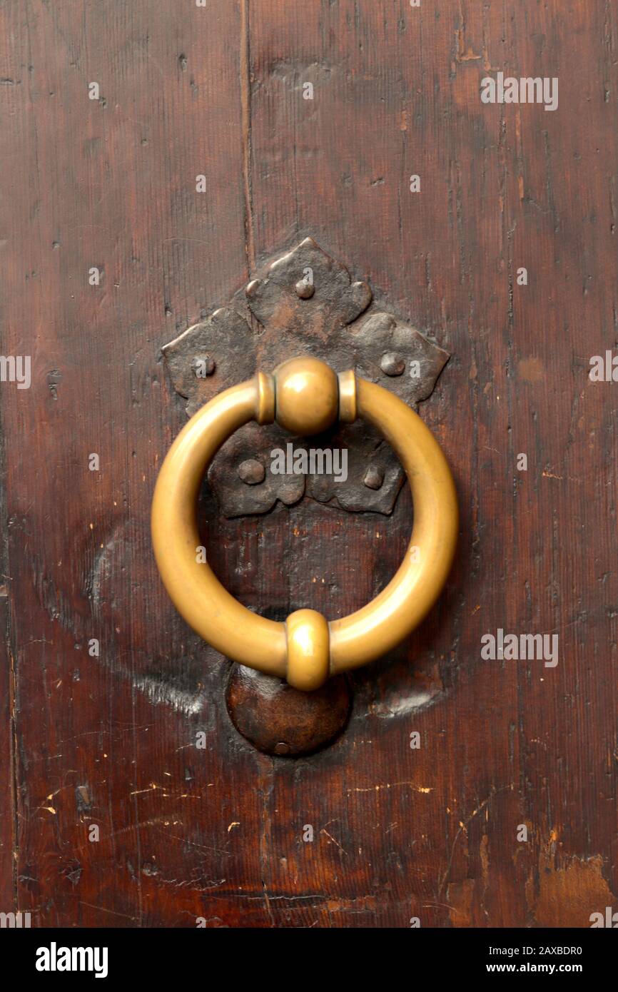 Bronze metal antique vintage door knock or knocker on an old wood door ...