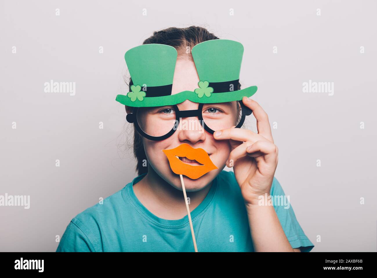 Young girl is preparing for the St Patricks Day party with photo booth ...