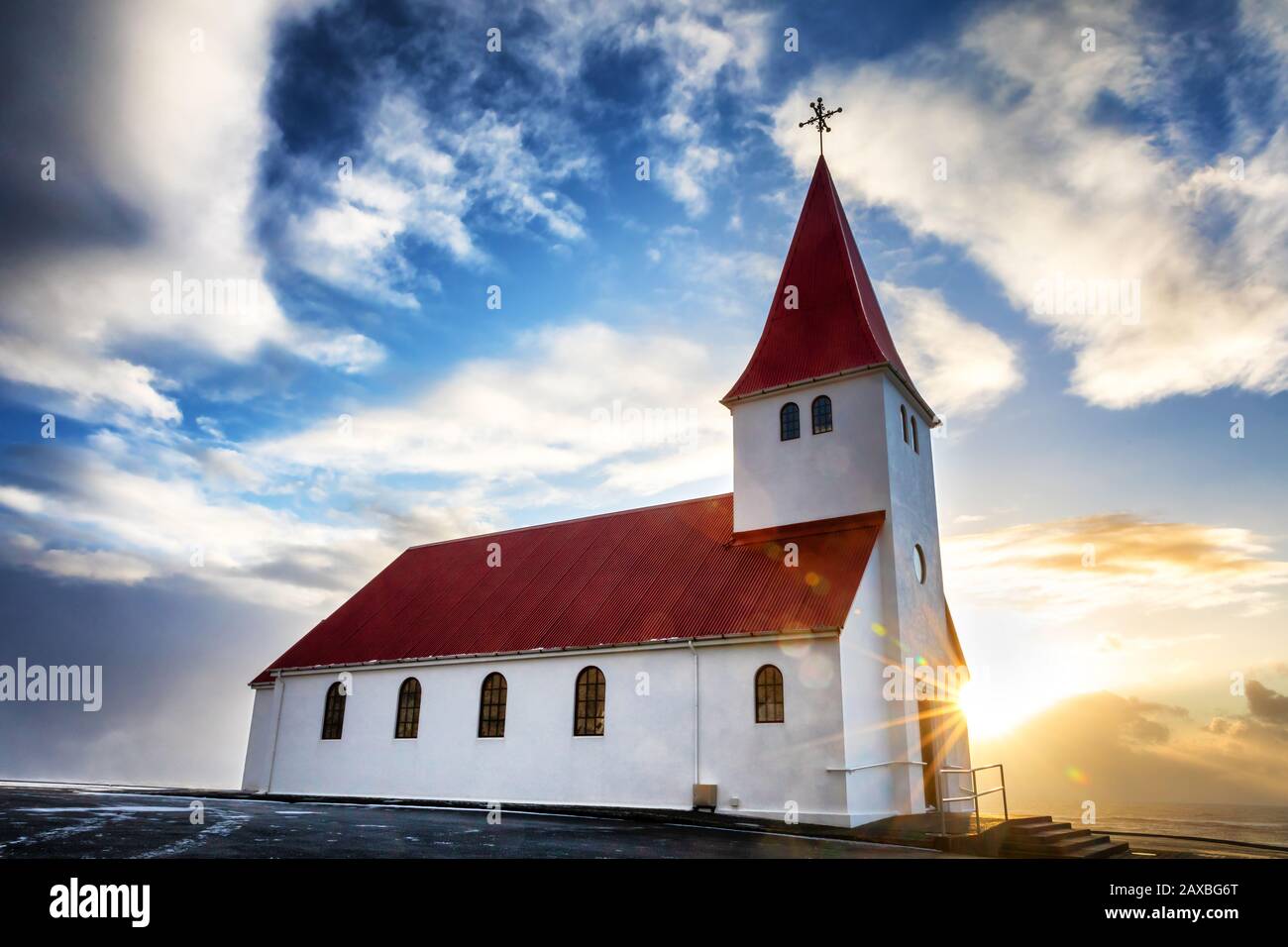 The picturesque Vik i Myrdal Church in Vik, Iceland. The sun is rising ...