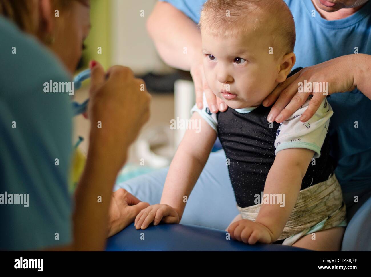 Portrait of a baby with cerebral palsy on physiotherapy in a children ...