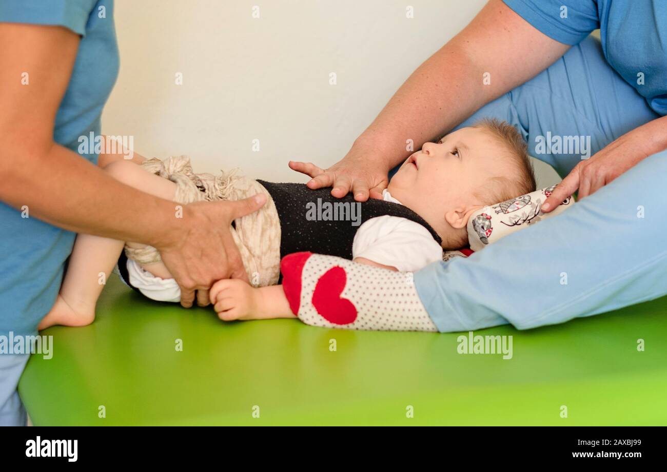 Portrait of a baby with cerebral palsy on physiotherapy in a children ...
