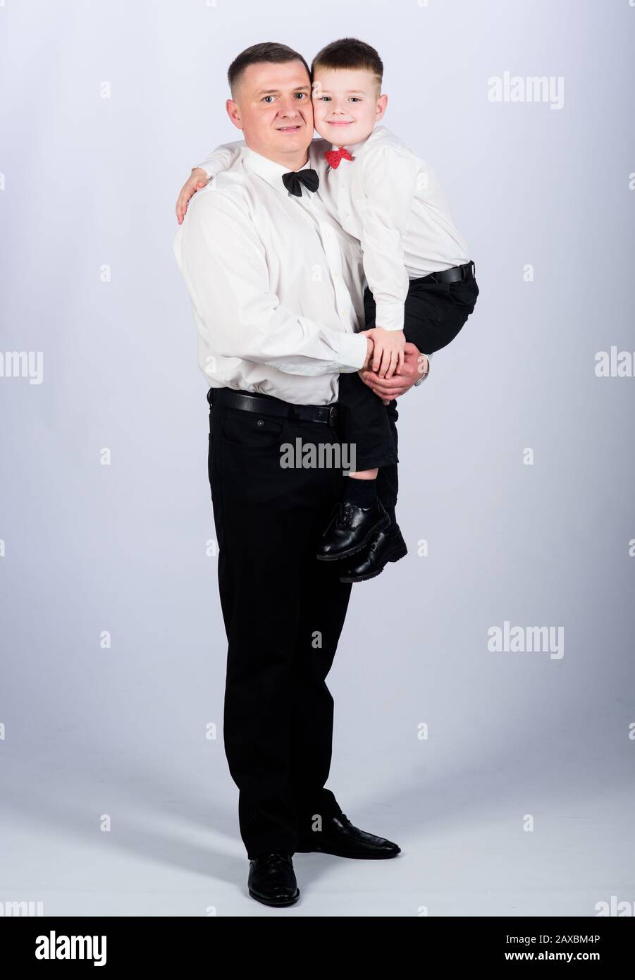 Little son following fathers example of noble man. Family holiday ...