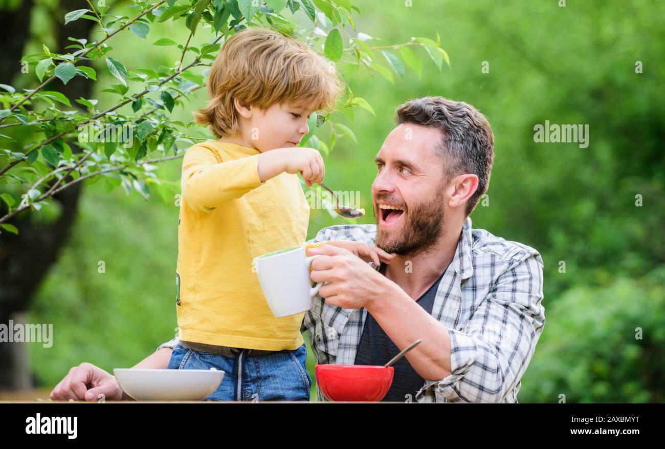 Father son eat food and have fun. Feeding baby. Menu for children ...