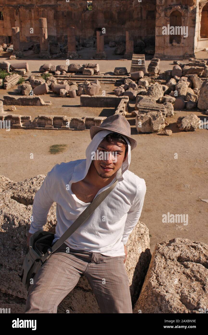 Man sitting on a Roman ruins in Baalbek, Lebanon Stock Photo - Alamy