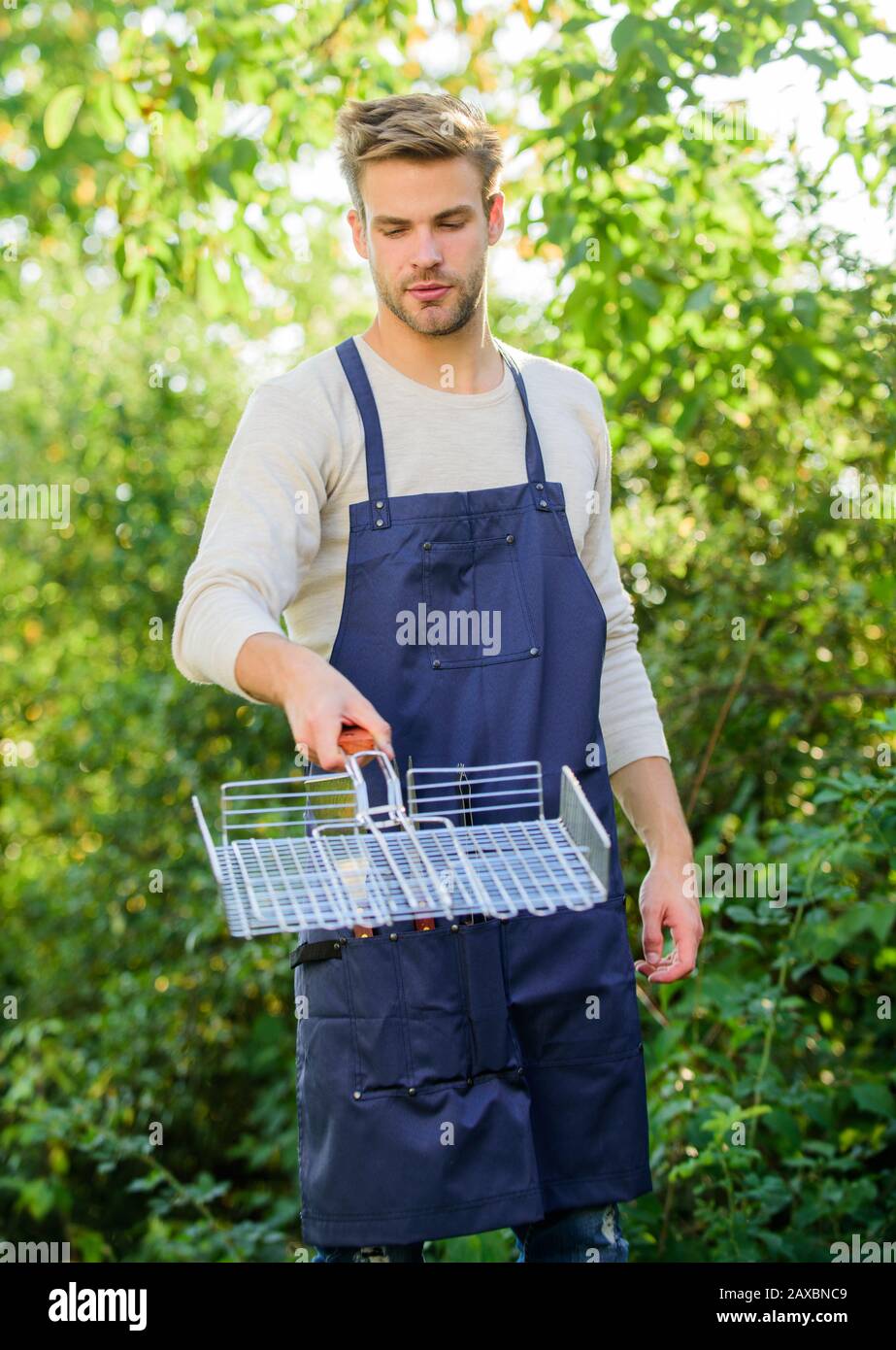 Healthy meal. Recipe grill. Picnic concept. Handsome guy cooking food. Man hold grilling grid ...