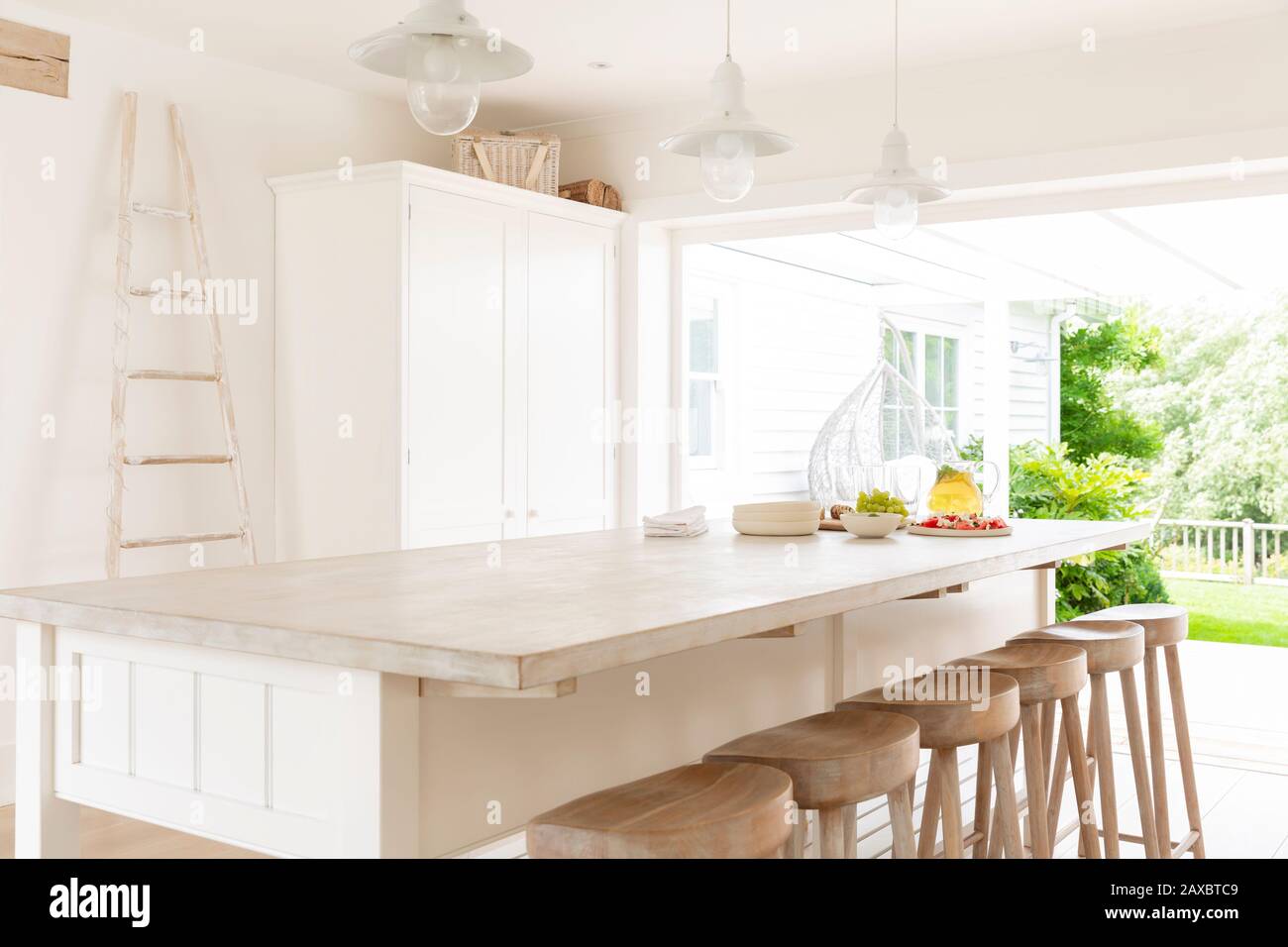 Simple white and wood home showcase kitchen Stock Photo - Alamy
