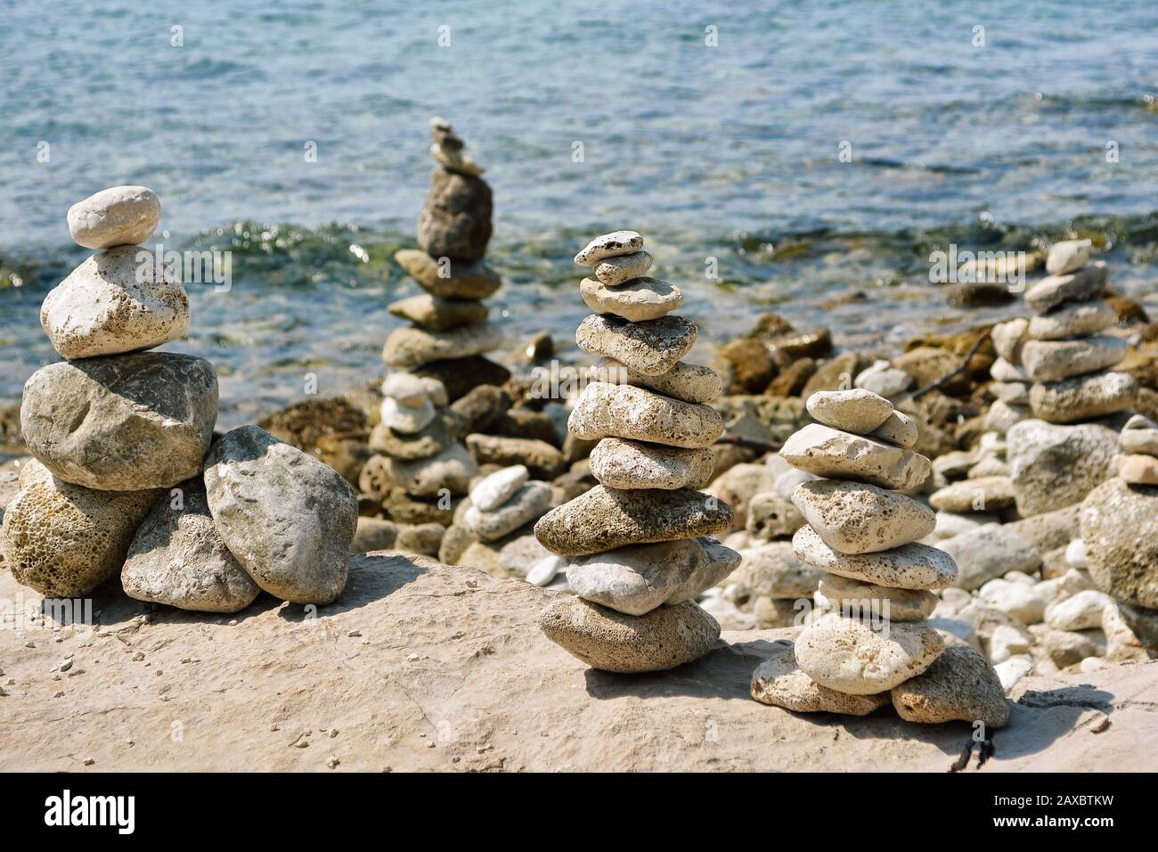 Pyramids of stones on the rocky coast of the Adriatic sea in Croatia ...