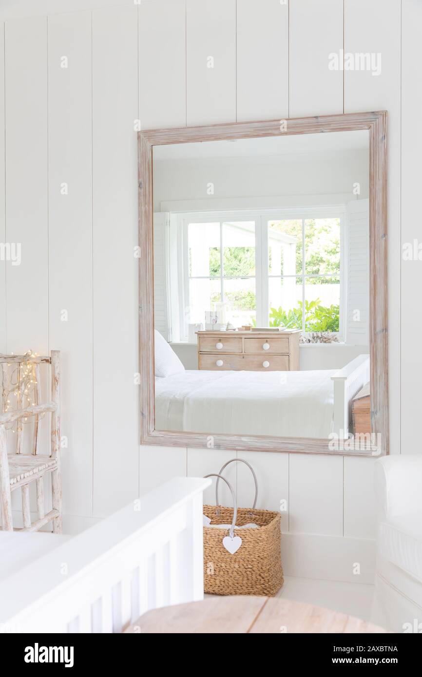 Reflection in mirror of white home showcase bedroom Stock Photo - Alamy