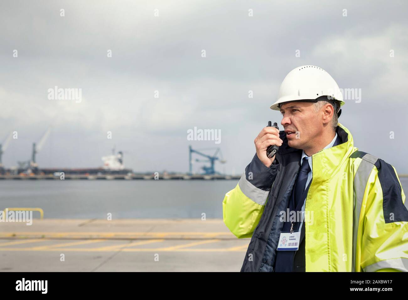 Dock manager with walkie-talkie at shipyard Stock Photo - Alamy