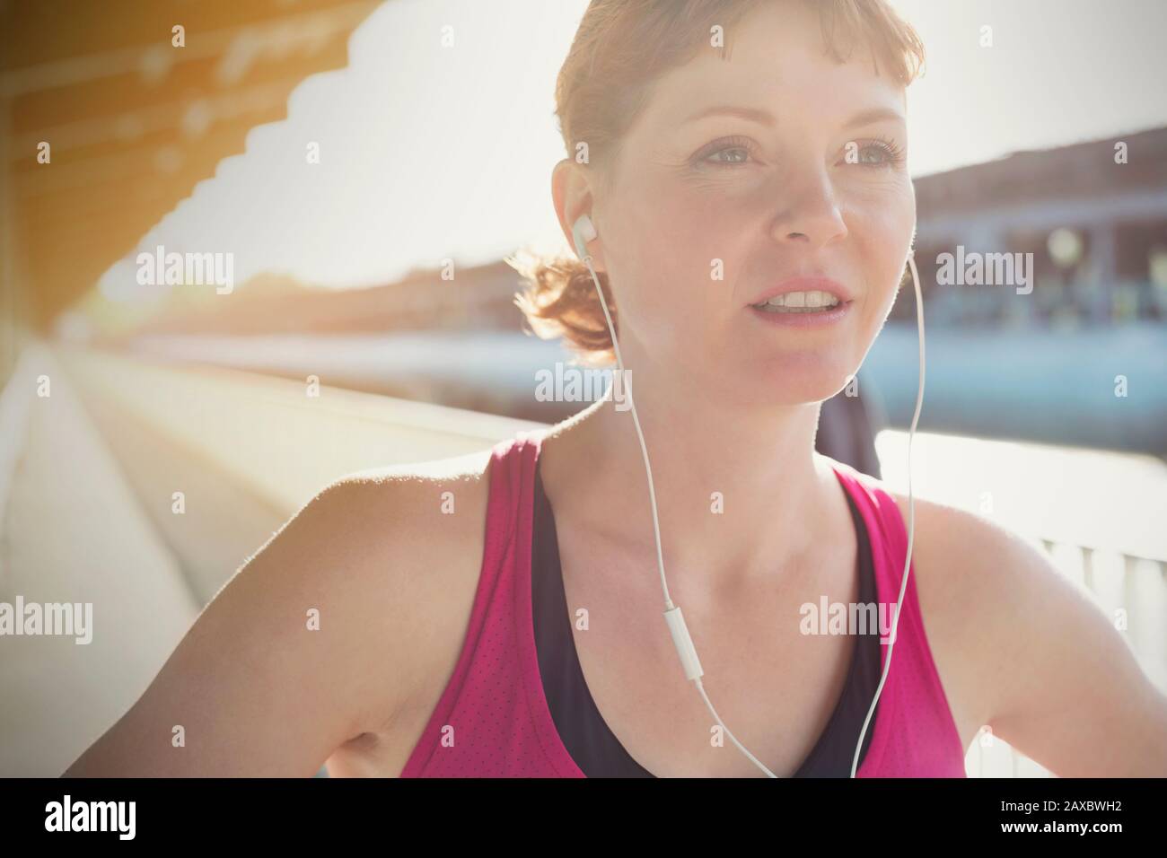 Young female runner listening hi-res stock photography and images - Alamy