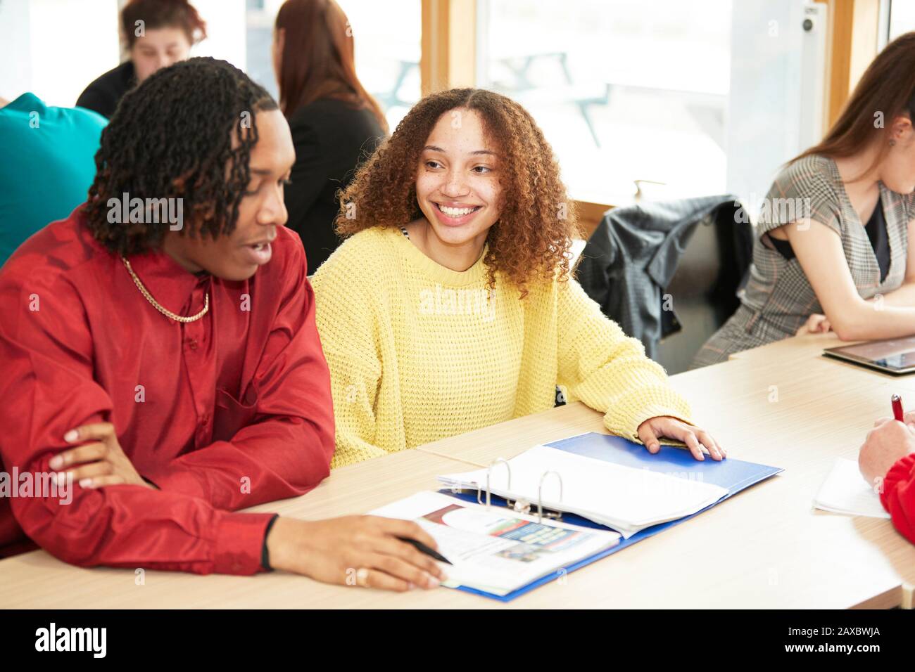 Smiling college students studying in classroom Stock Photo - Alamy