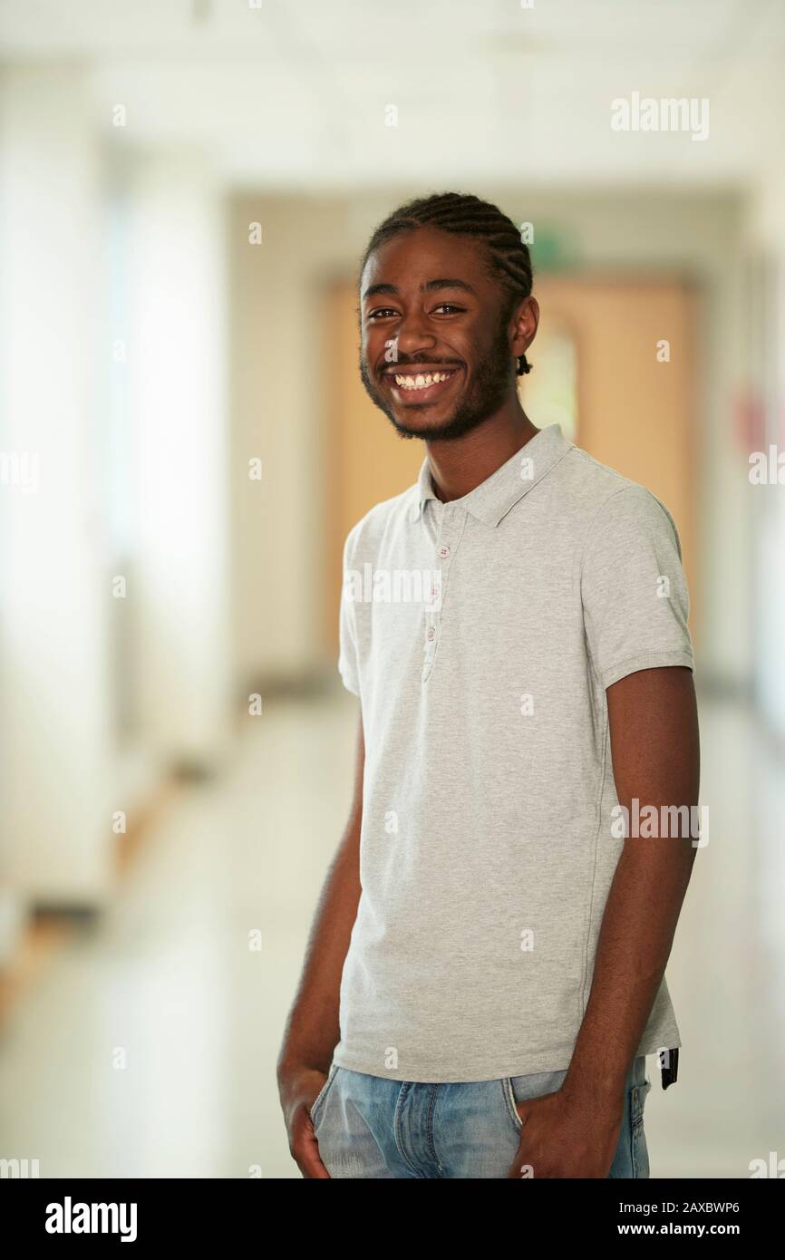 Portrait confident male college student in corridor Stock Photo - Alamy