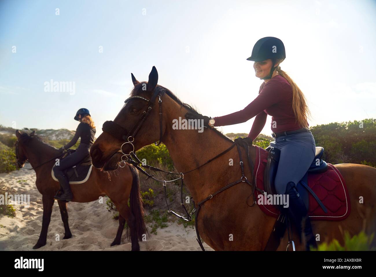 Young women horseback riding on beach Stock Photo - Alamy Young women horseback riding on beach Stock Photo - Alamy